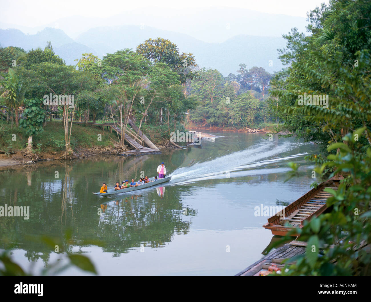 Outboard powered longboat on the Melinau River Mulu National Park ...