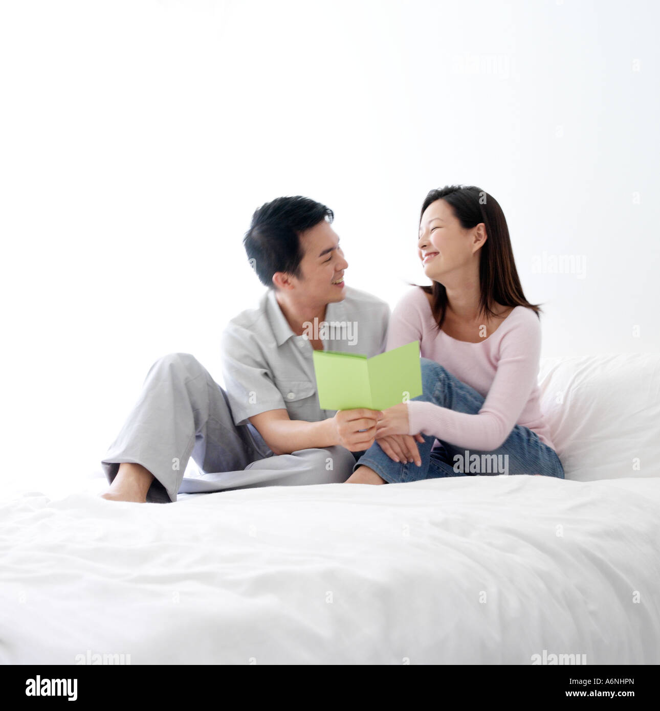 Couple reading greeting card Stock Photo - Alamy