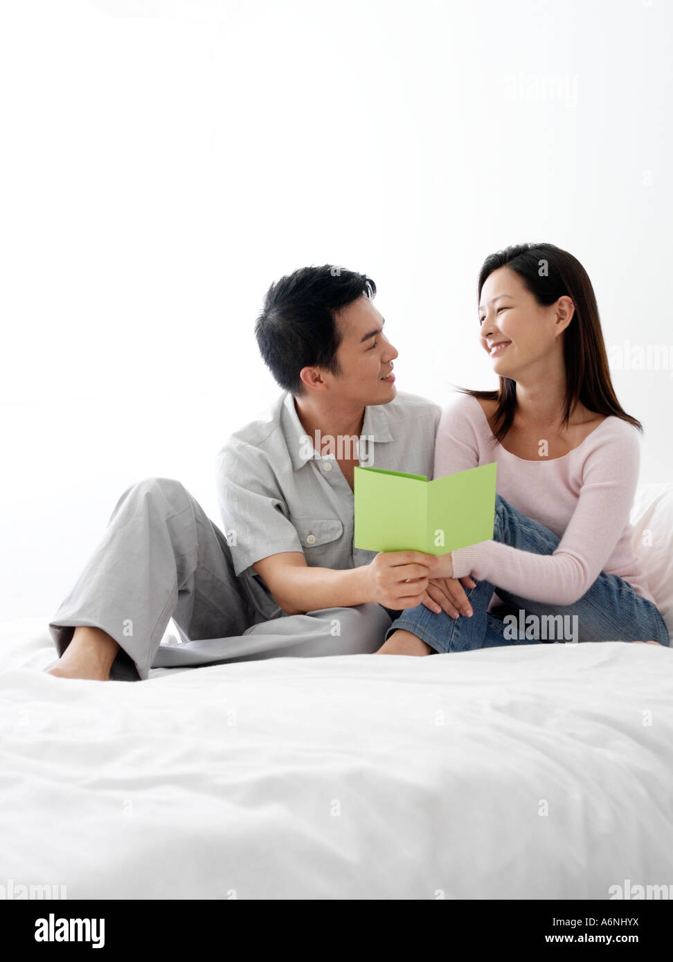 Couple reading greeting card Stock Photo - Alamy