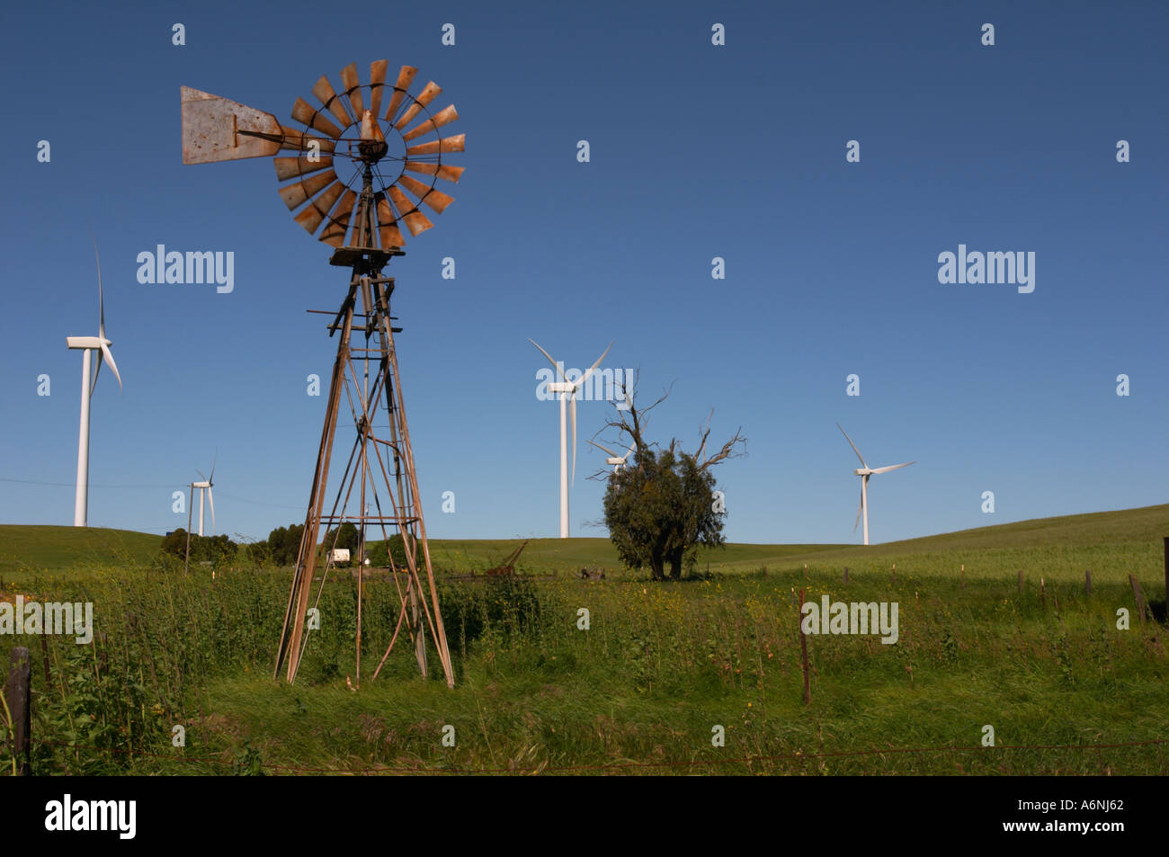 Modern Wind Generators and old wind pump Stock Photo - Alamy
