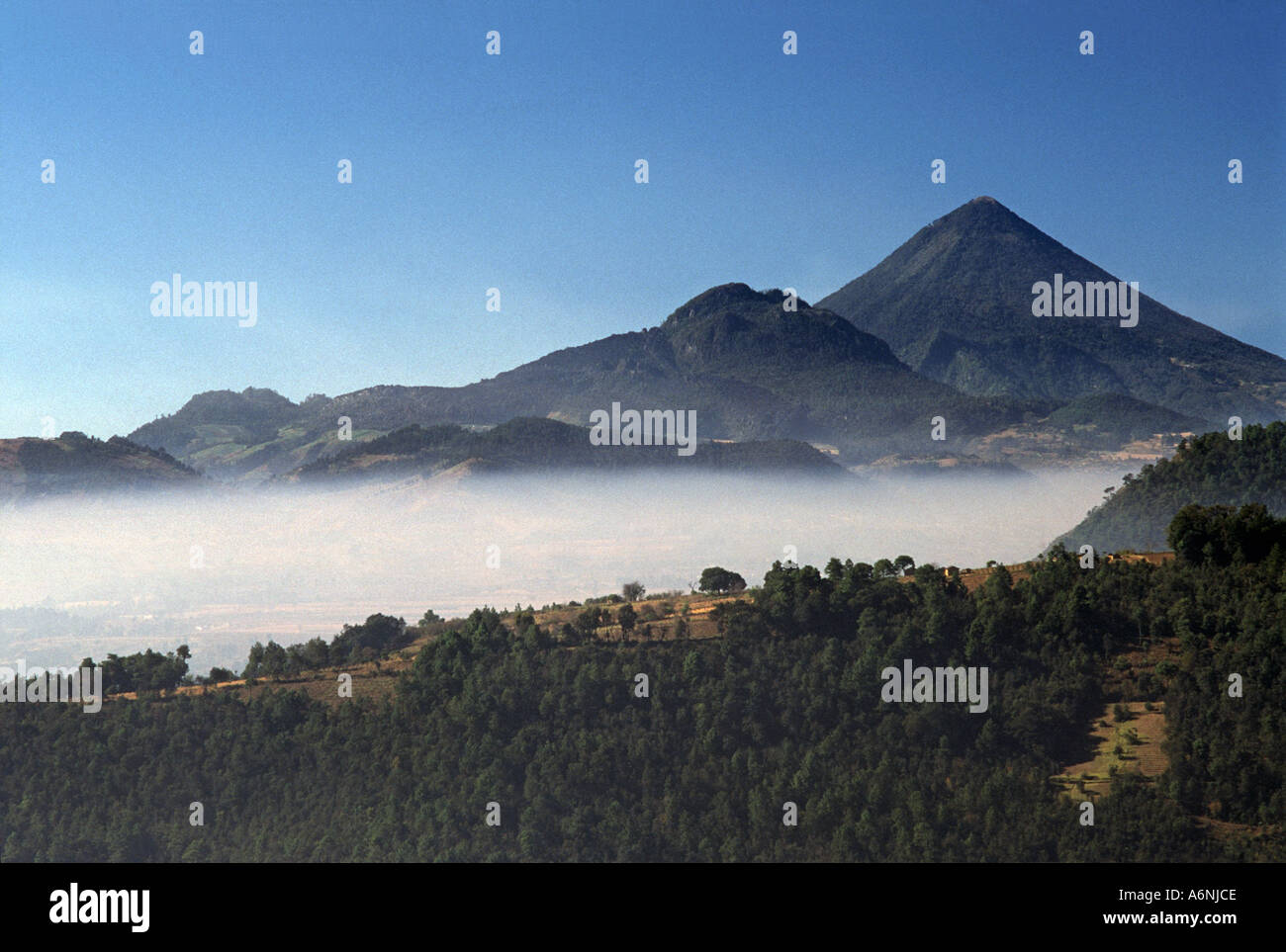Santa Maria volcano visible across the mist shrouded Quezaltenango ...