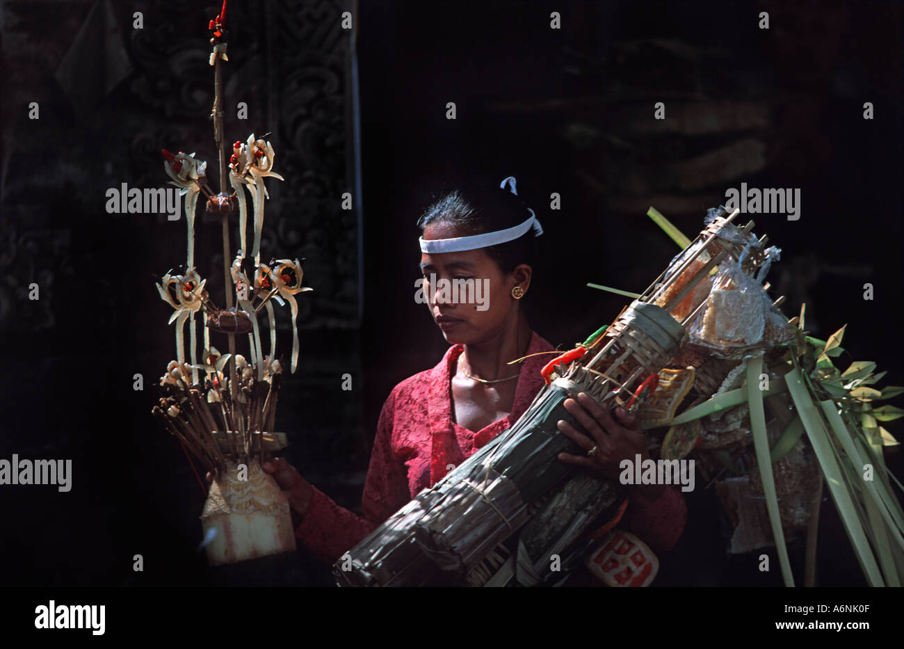 Balinese woman arrives at the temple with a religious offering Full ...