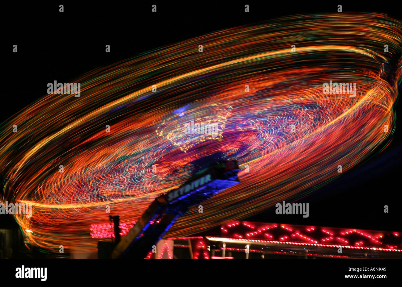A colourful Fairground Ride at night Stock Photo - Alamy