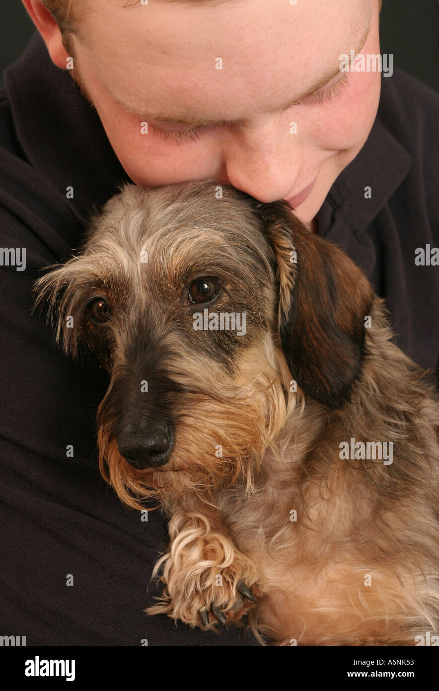 Young man cuddling a dog Stock Photo - Alamy