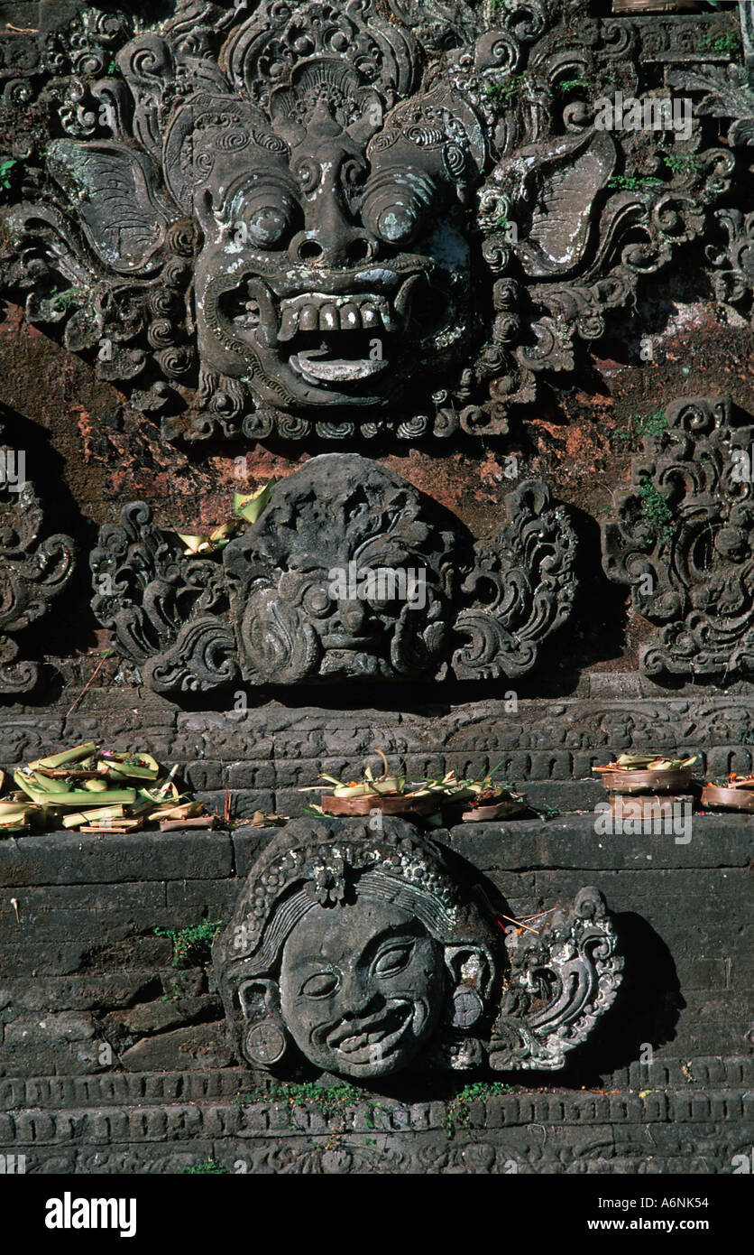 Stone wall with mythycal bas relief carvings in the Balinese style Ubud ...