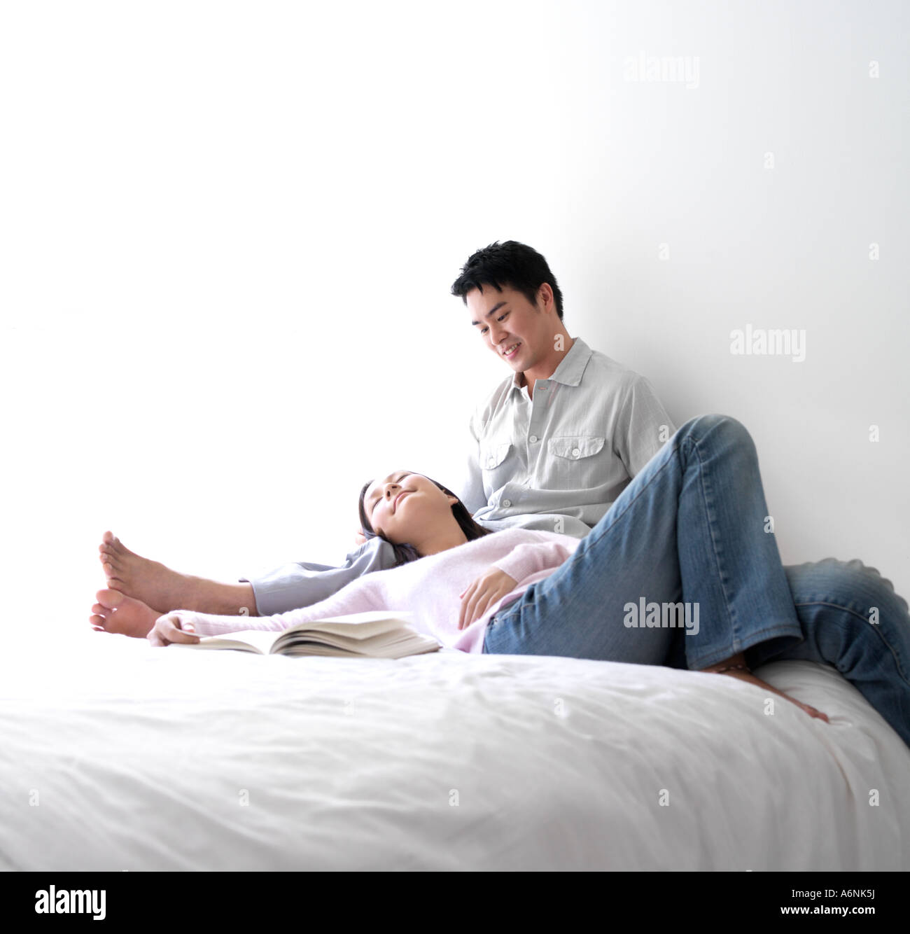 Woman lying in man's lap, man resting Stock Photo - Alamy