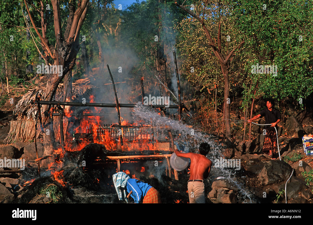 Villagers trying to extinguish a fire burning down a drink stall Amed ...