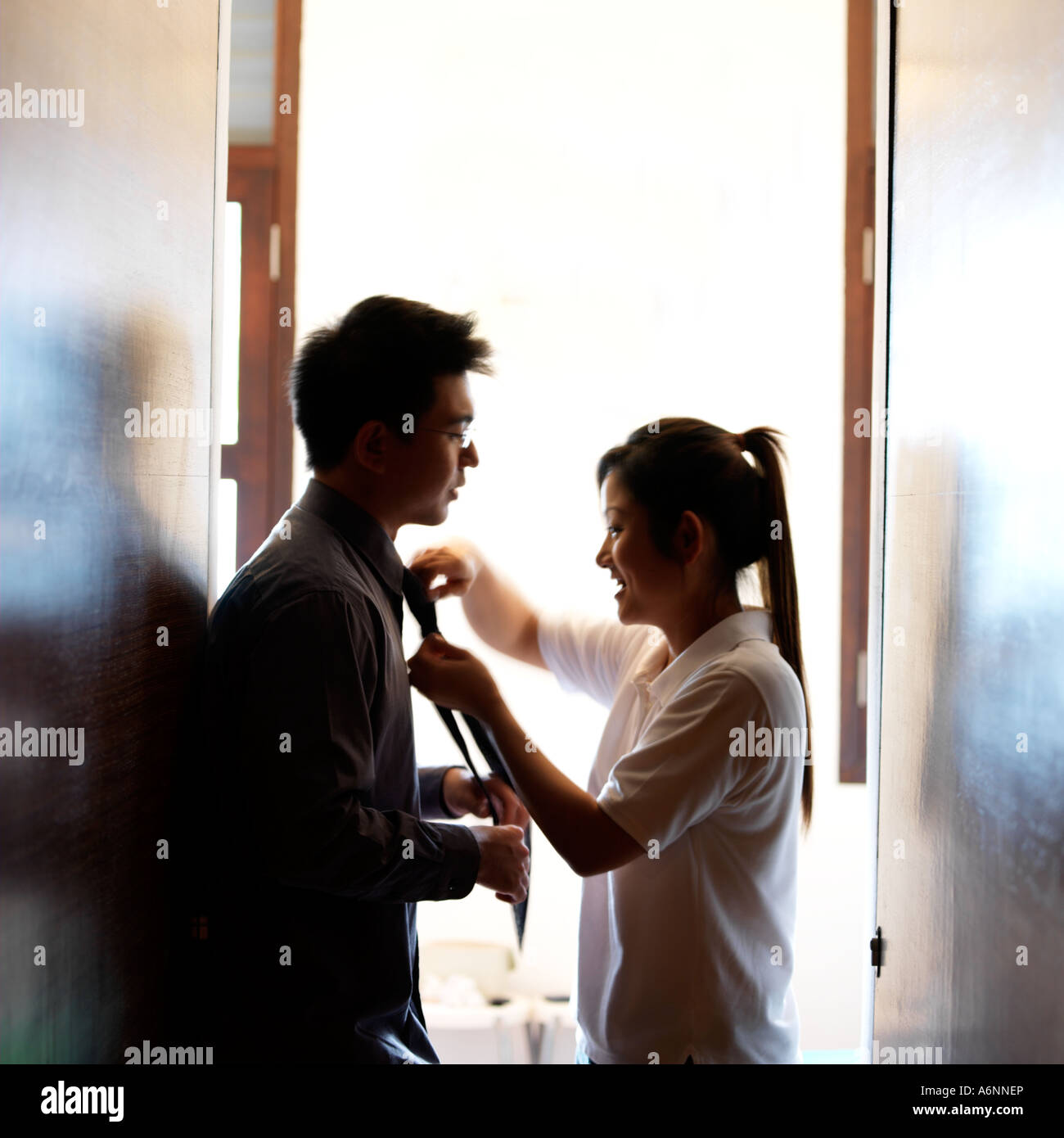 Couple fixing tie hi-res stock photography and images - Alamy