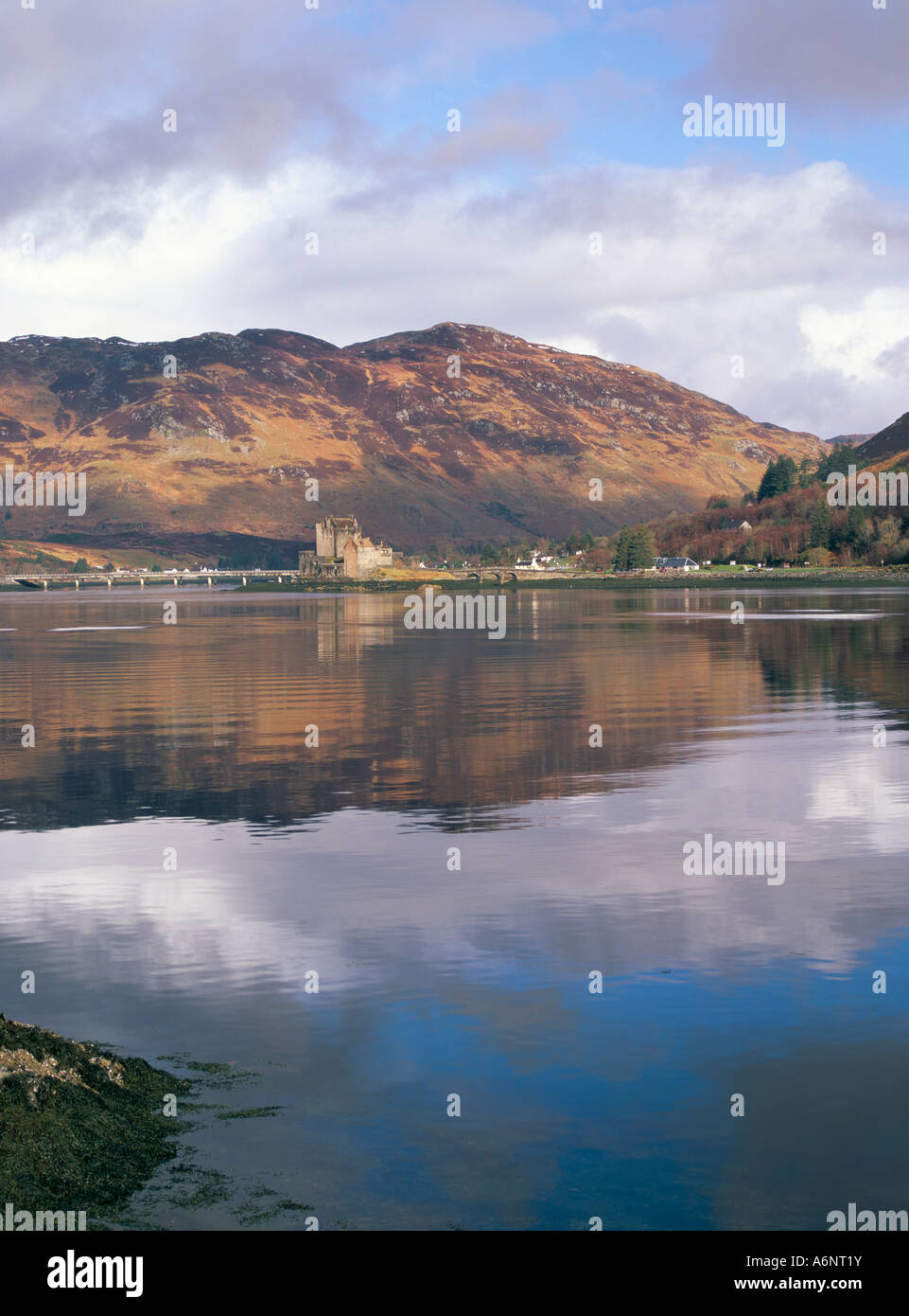 Eilean Donan castle reflected in calm water of Loch Duich from Totaig ...