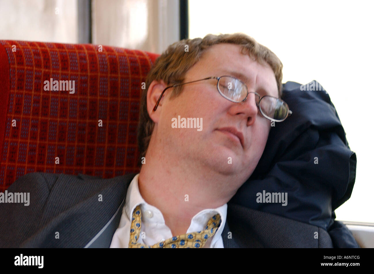 Asleep British business man on train London UK Stock Photo - Alamy