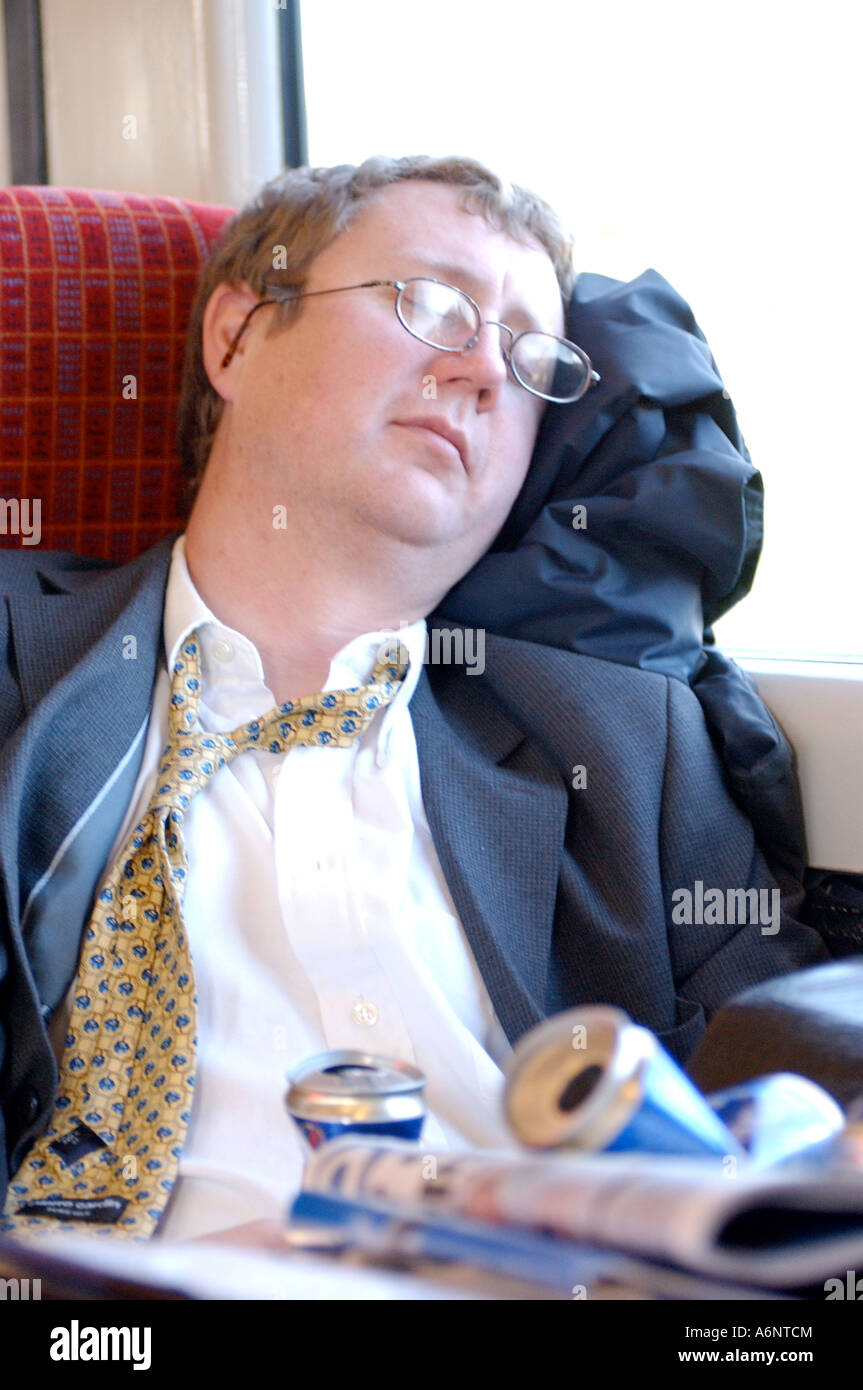 Drunk British business man on train London UK Stock Photo - Alamy