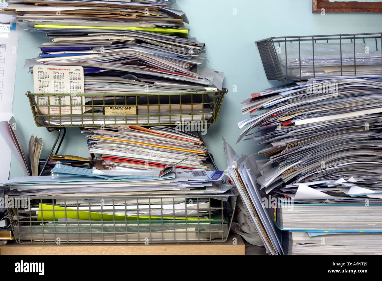 badly stacked and over-filled wire in-trays Stock Photo - Alamy