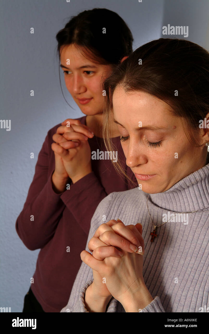 Two girls in fervent prayer Stock Photo - Alamy
