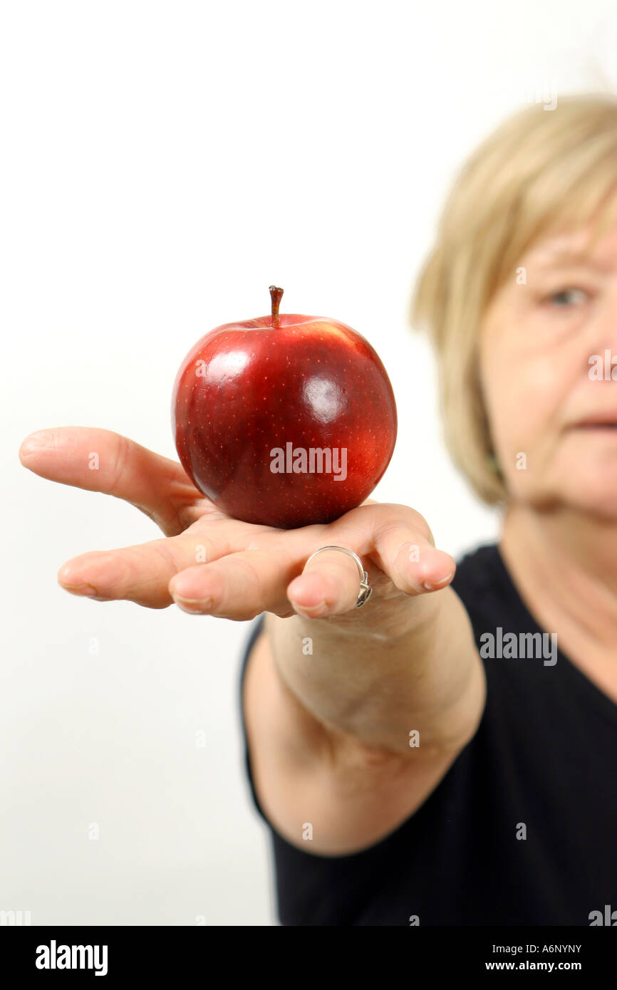 Hand holding shiny red apple hi-res stock photography and images - Alamy