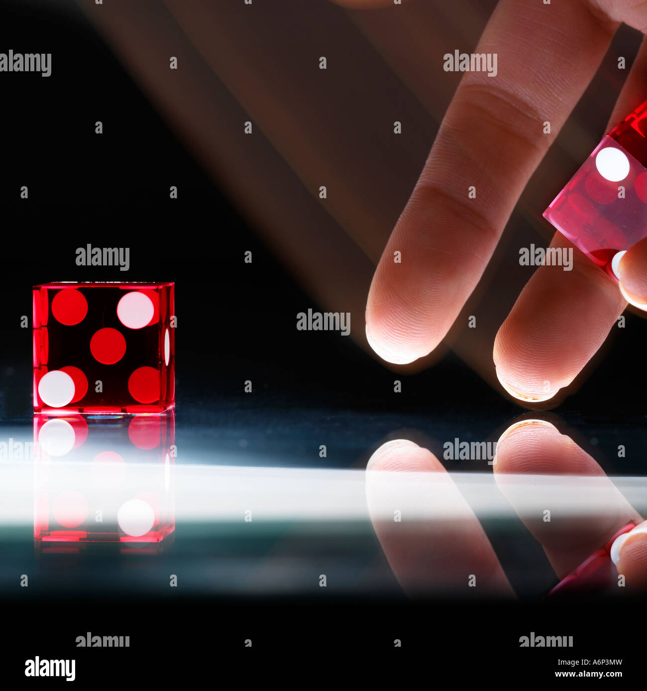hand rolling dice with motion blur Stock Photo - Alamy