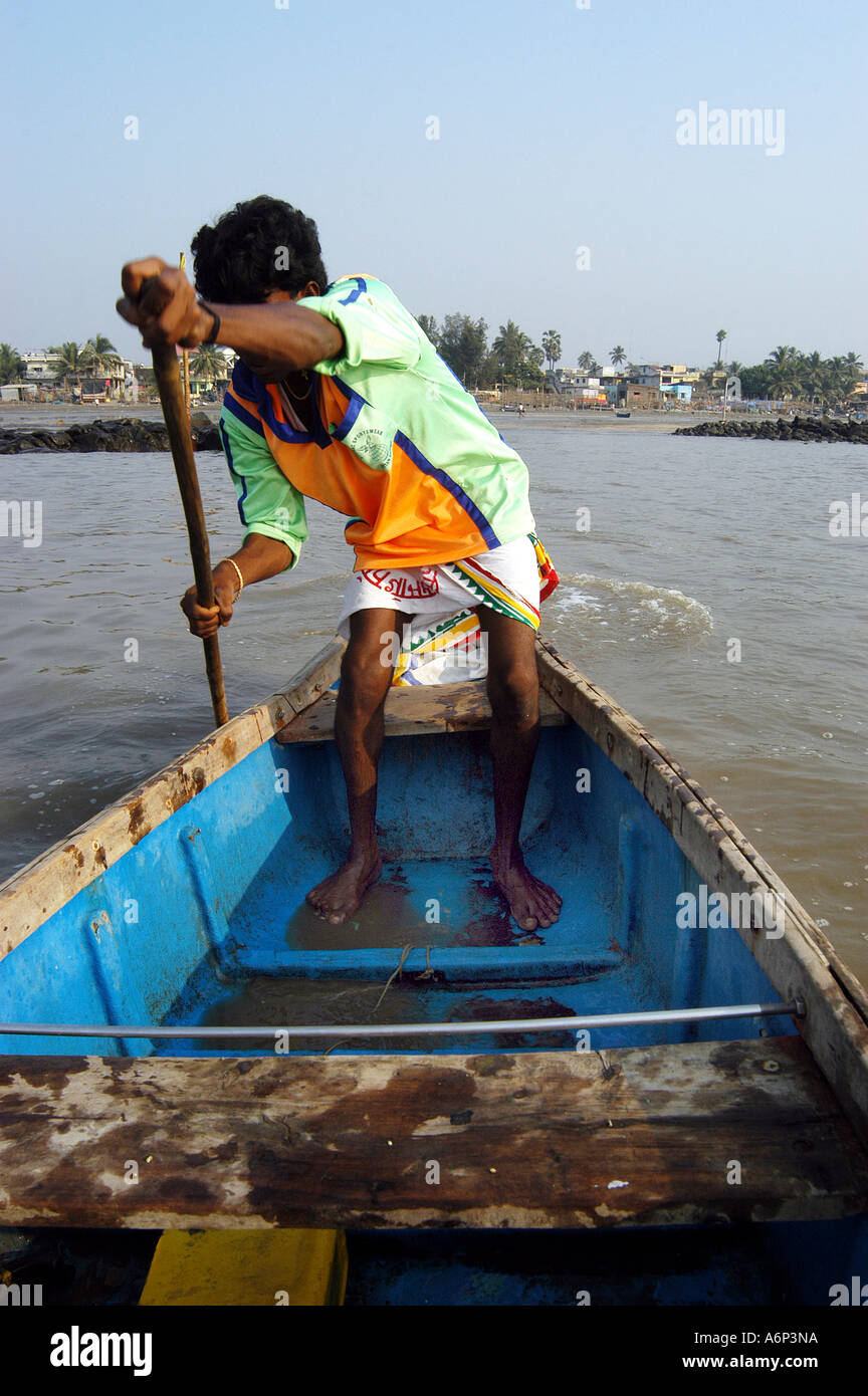 Indian Koli fisherman leaves for fishing rowing a boat at Uttan Beach ...