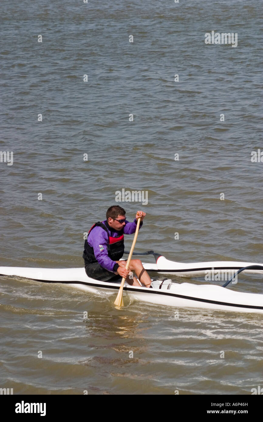 Man on outrigger canoe in Somme estuary French France St Valery Somme ...