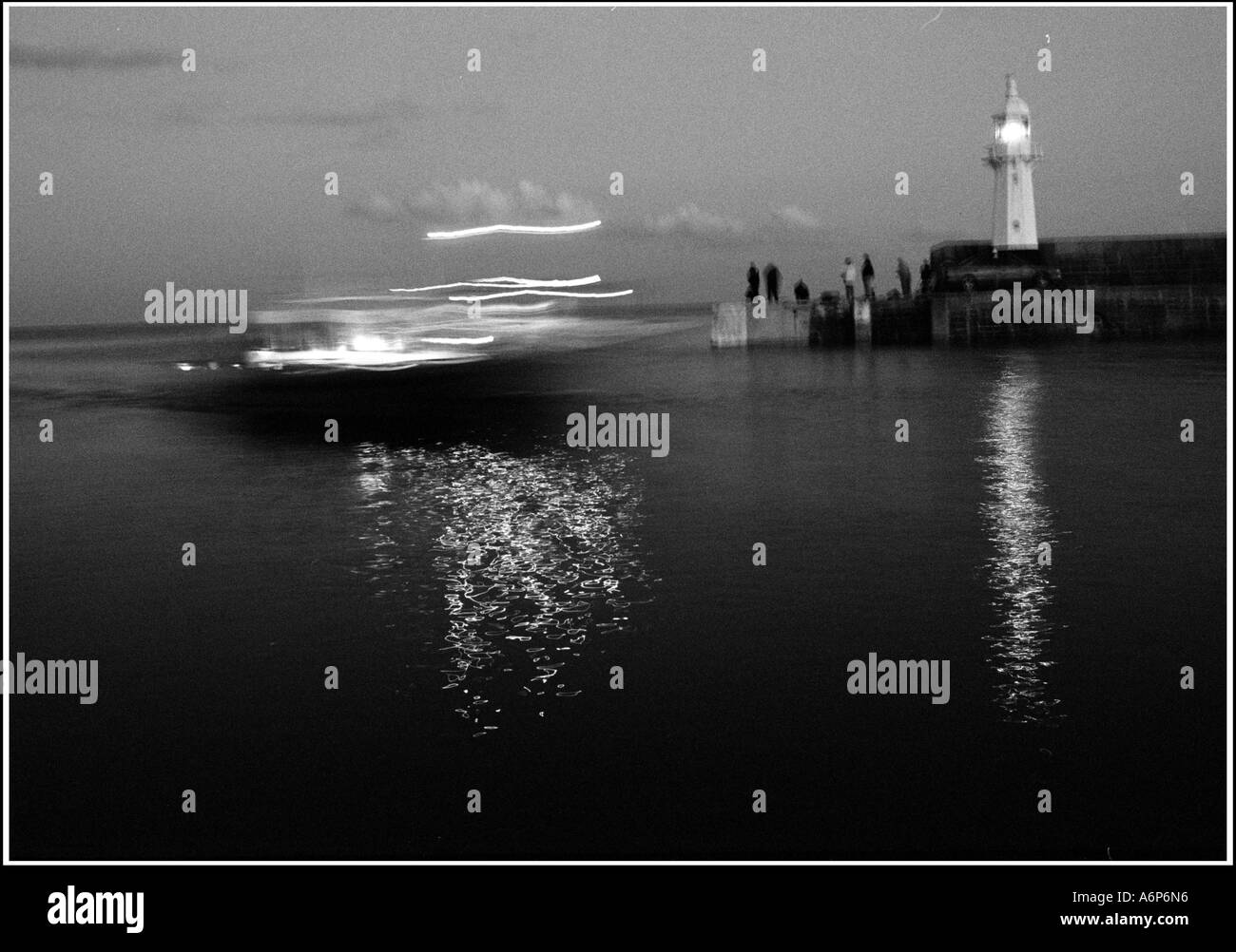 A fishing boat returning to harbour in the small traditional fishing ... A fishing boat returning to harbour in the small traditional fishing ...
