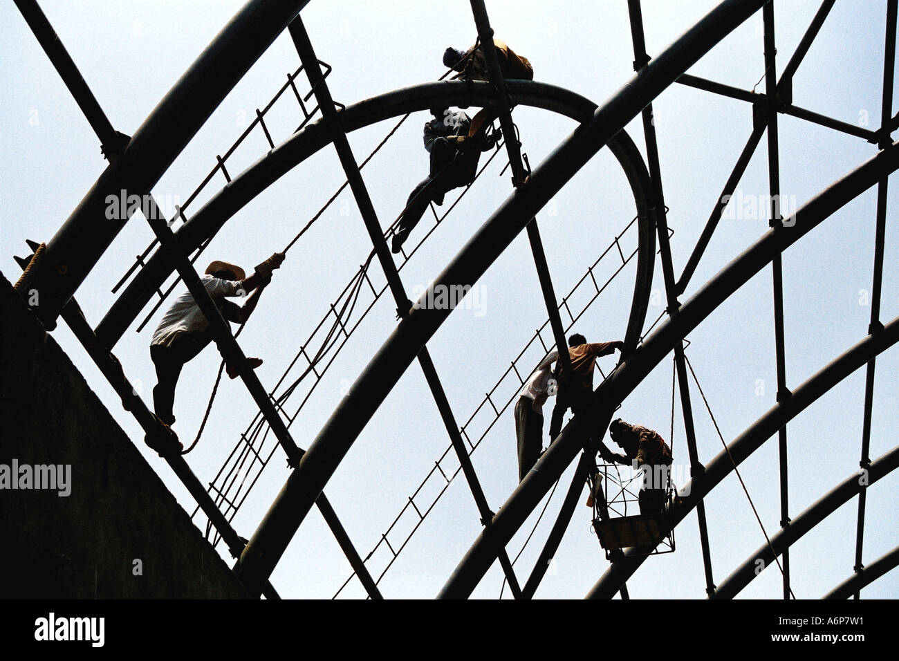 Construction workers building steel girders, India Stock Photo - Alamy