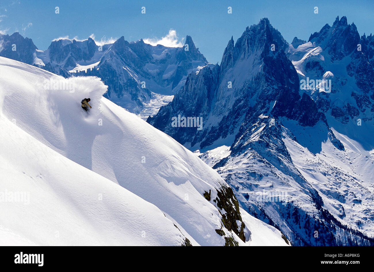 Snowboarder in deep powder snow off piste in the Chamonix area of the ...