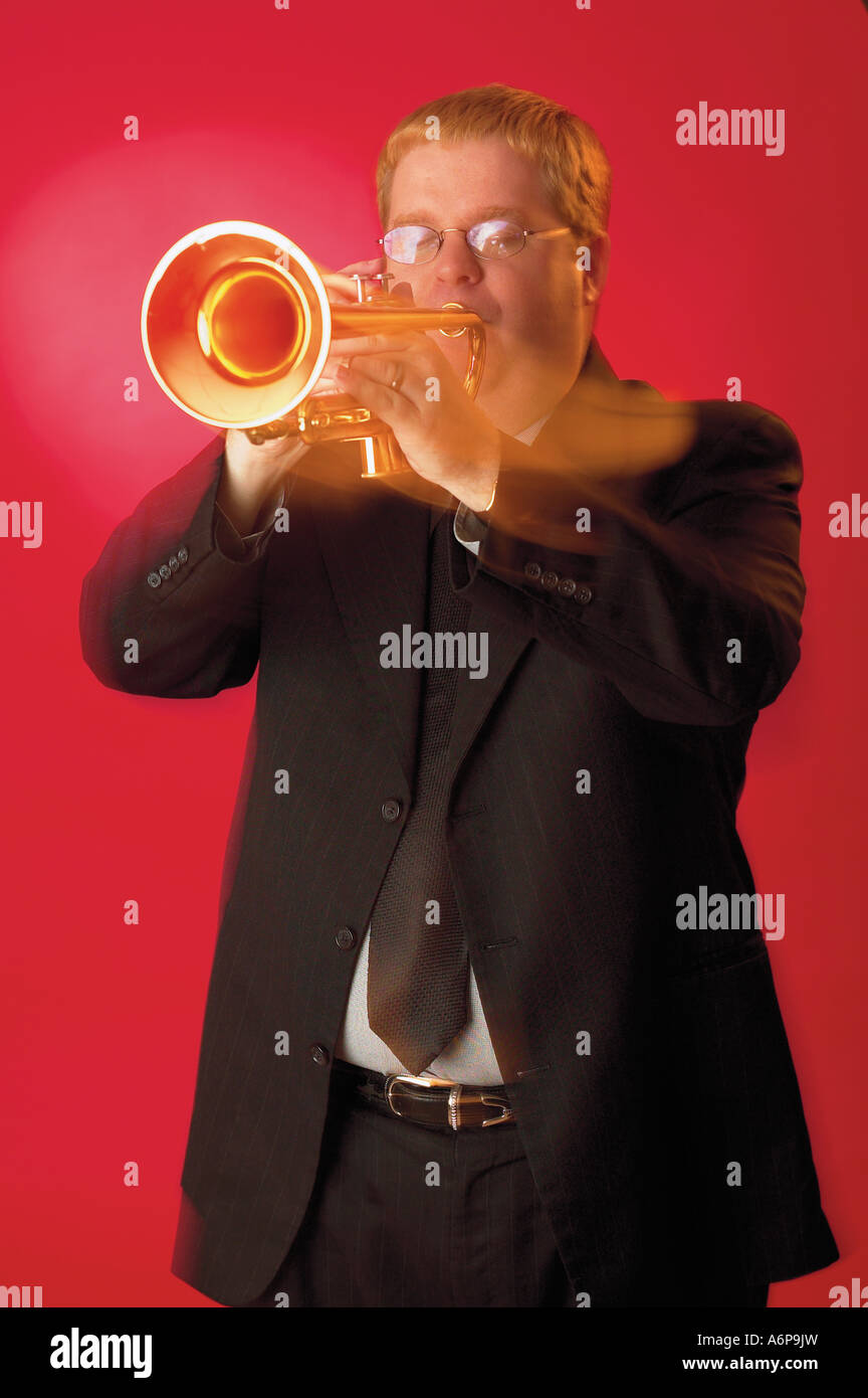 Professional trumpet player swings his horn while playing with eyes ...