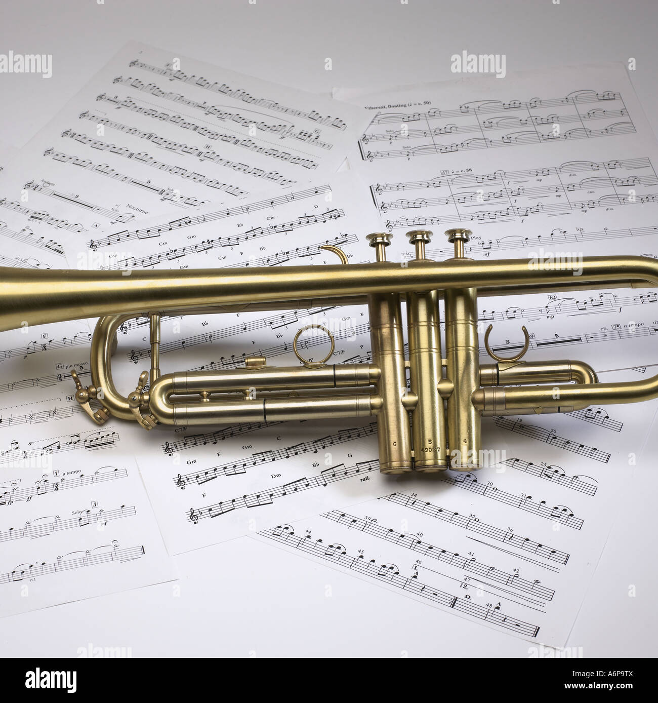 a trumpet sits on some sheet music Stock Photo - Alamy