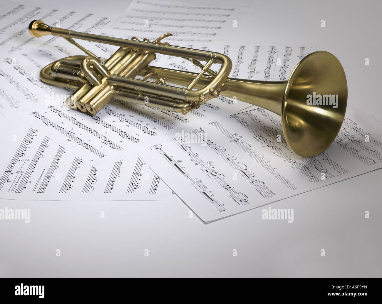 a trumpet sits on some sheet music Stock Photo - Alamy