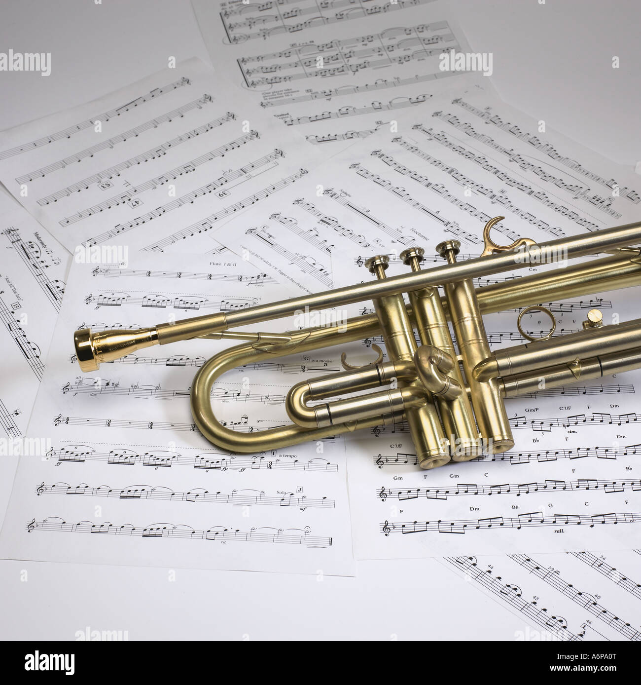 a trumpet sits on some sheet music Stock Photo - Alamy