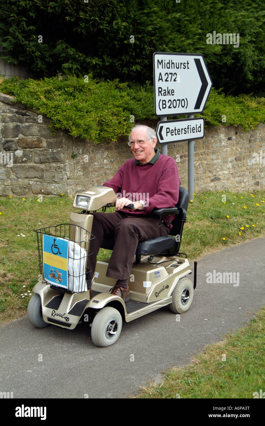 Electric powered mobility scooter Elderly scooter rider riding along ...
