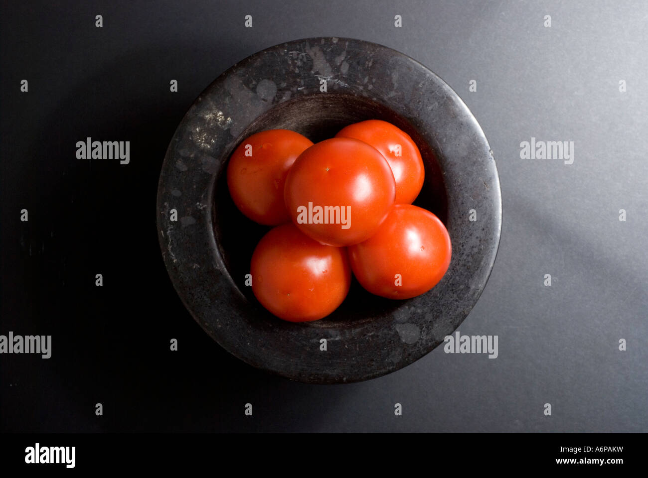 Tomatoes in a black marble bowl Stock Photo - Alamy
