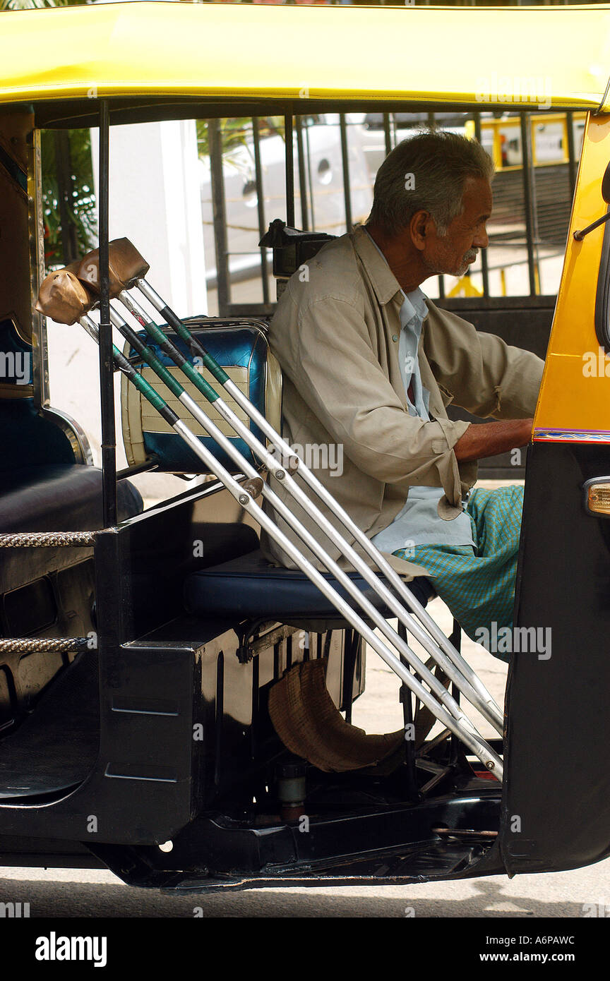 physically handicapped rickshaw driver drives a auto rickshaw in ...
