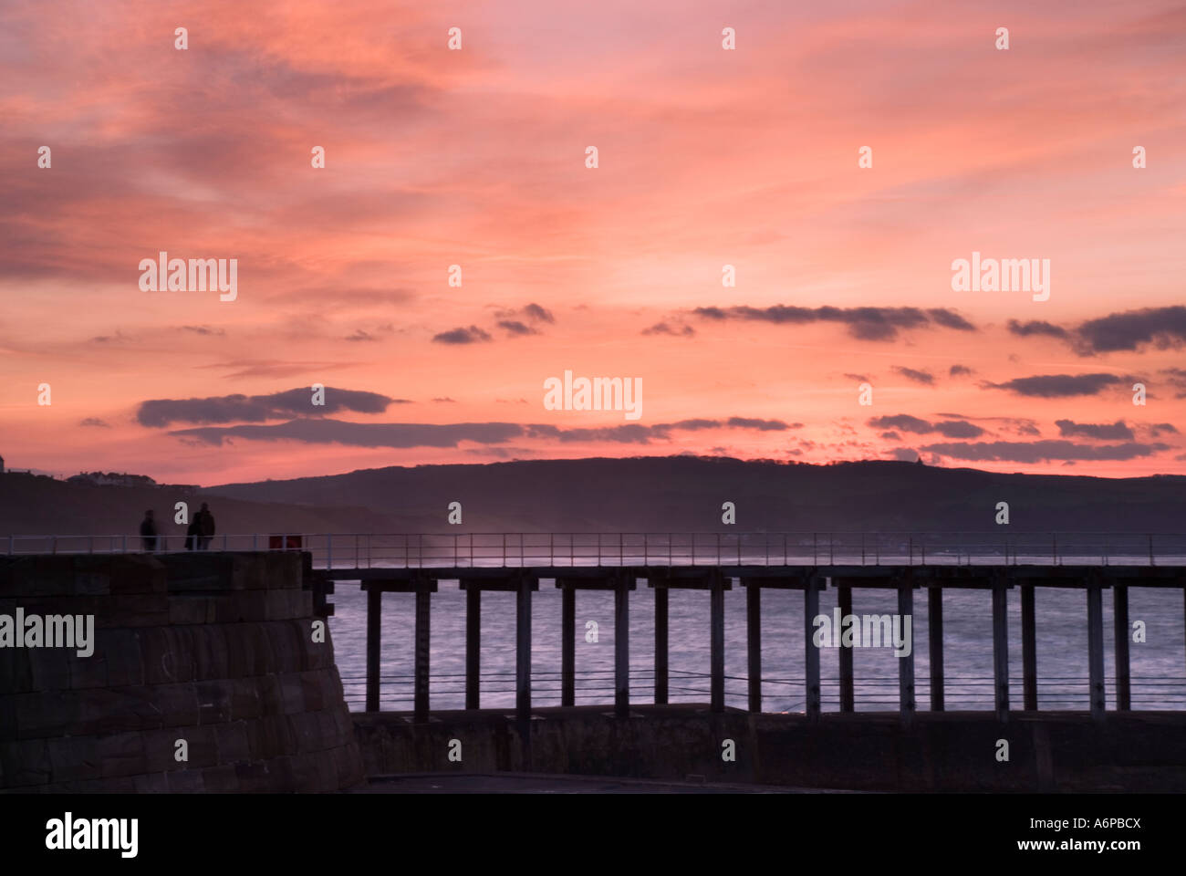 Whitby west pier at sunset Stock Photo - Alamy