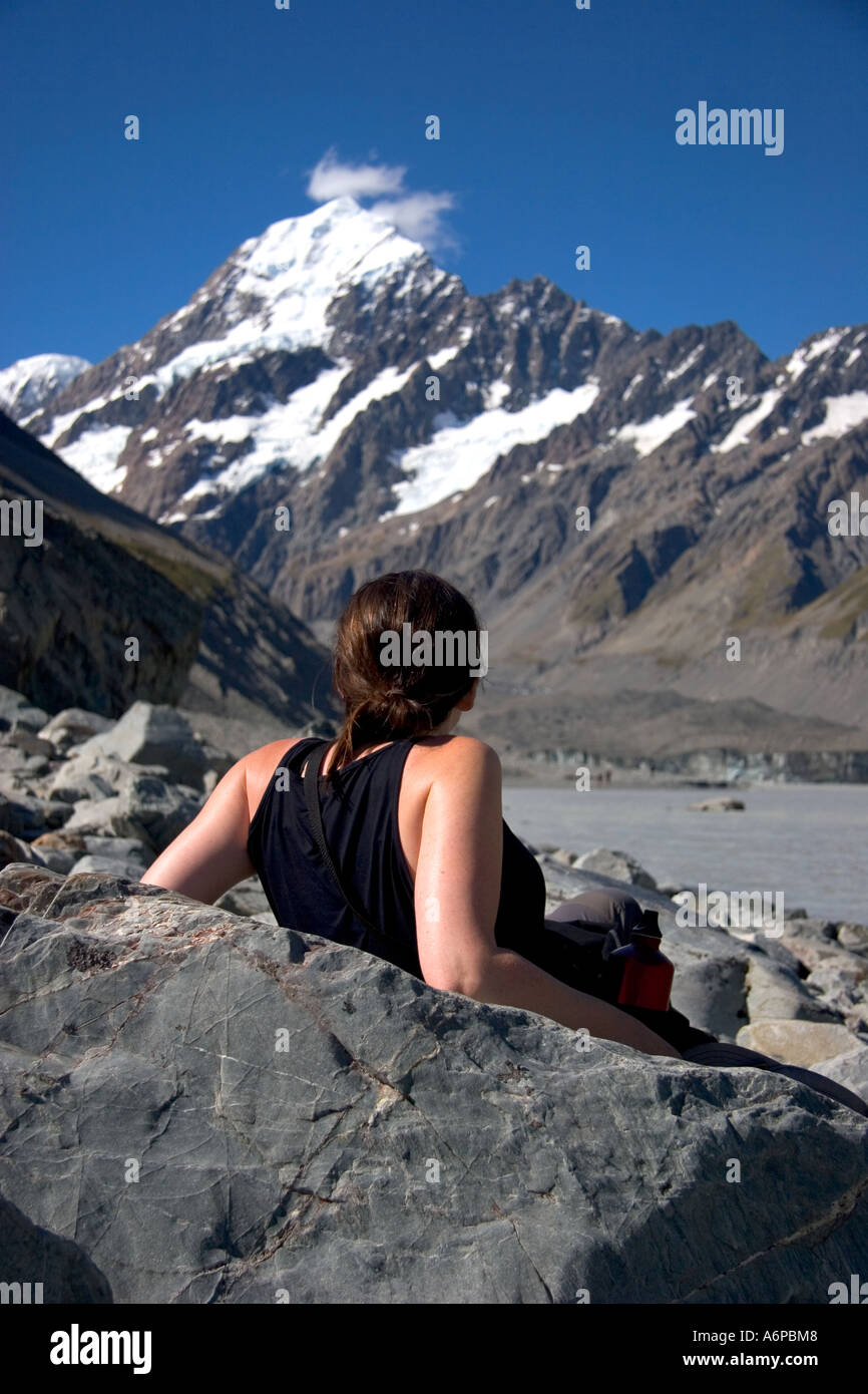 Female walker, resting and taking the view of Mount Cook and the Tasman ...