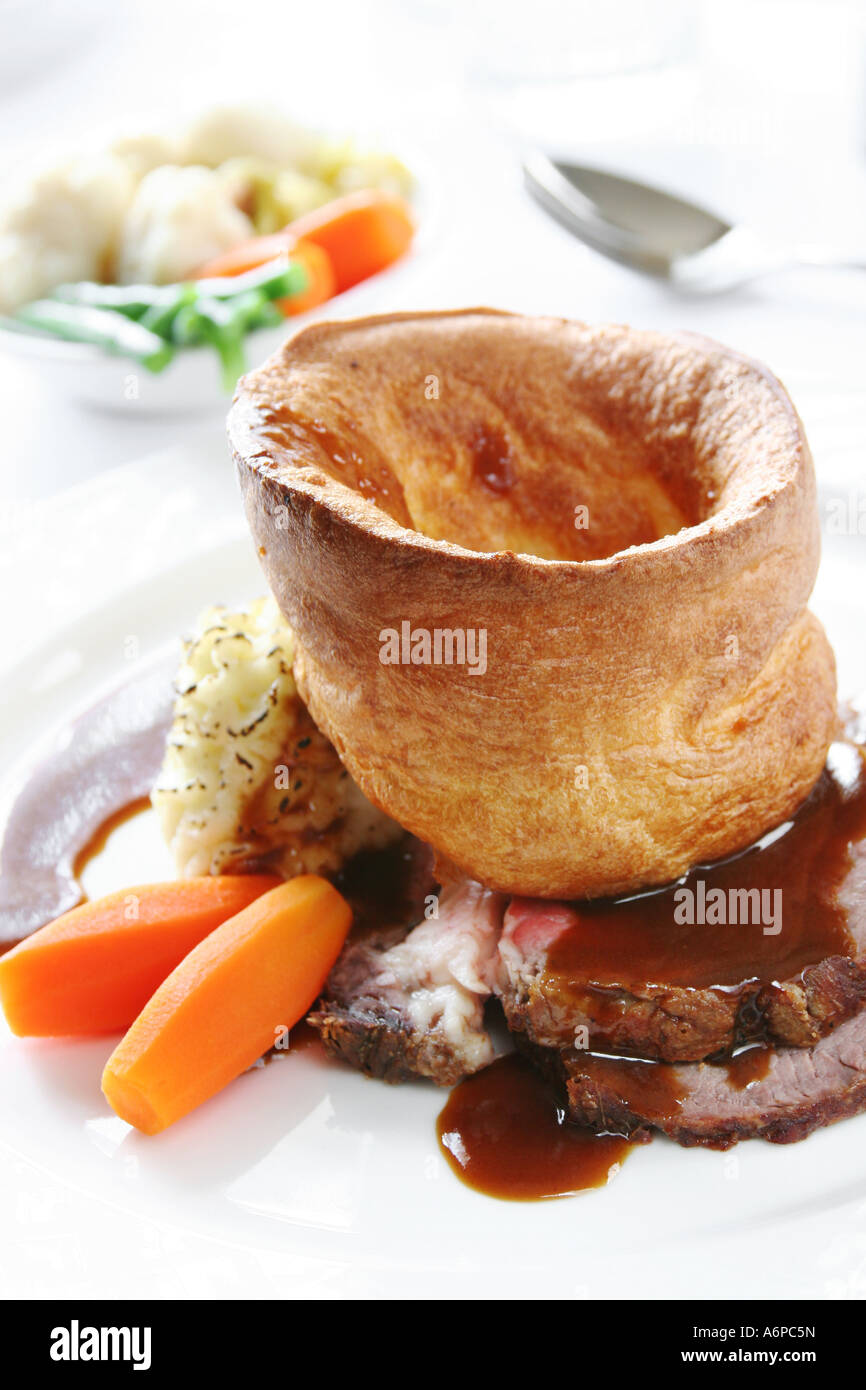 Beef cooked dinner with big yorkshire pudding and vegetables and gravy ...