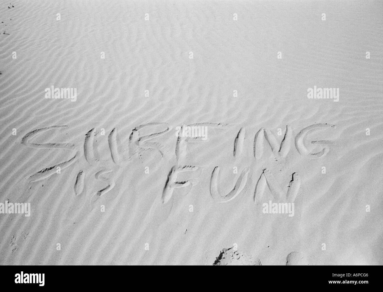 Surf graffiti written on a Moroccan beach 'surfing is fun' Stock Photo ...