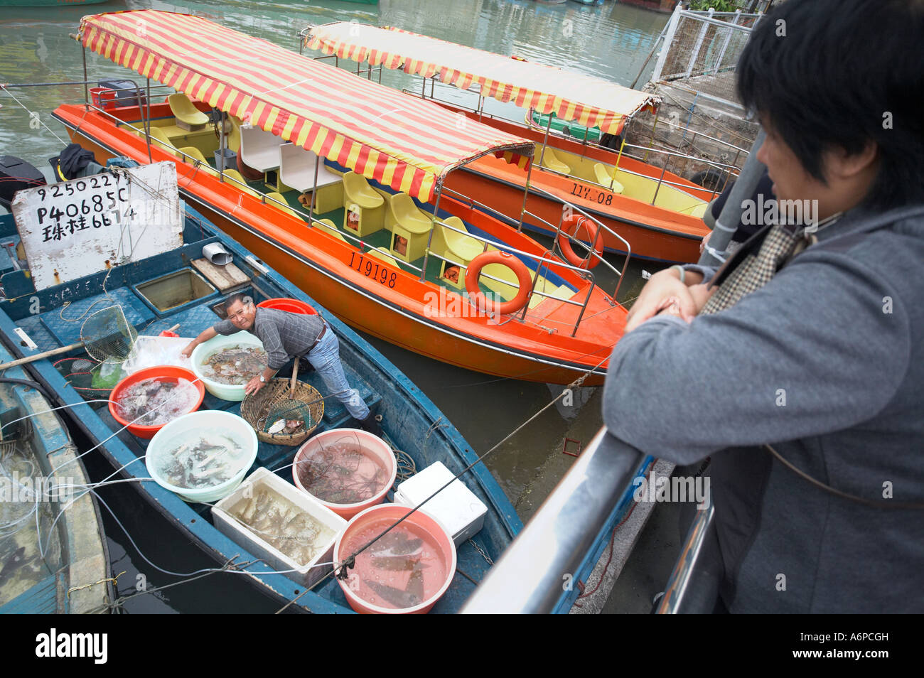 Fisherman selling fish in Tai O village Hong Kong Stock Photo - Alamy