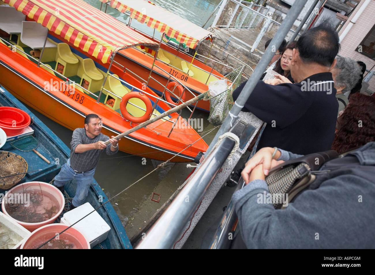 Fisherman selling fish in Tai O village Hong Kong Stock Photo - Alamy