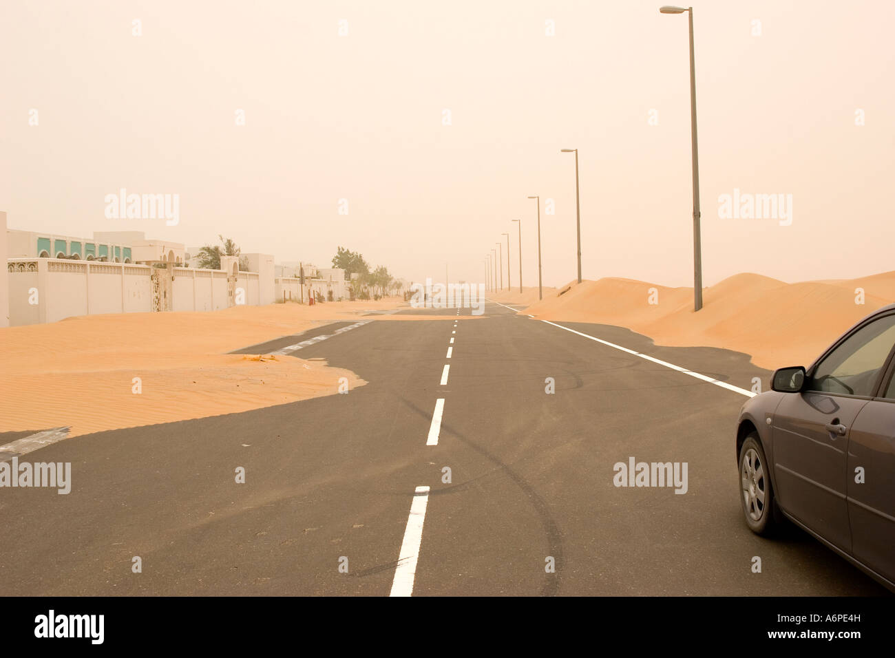 Sand drifting across the road Stock Photo - Alamy