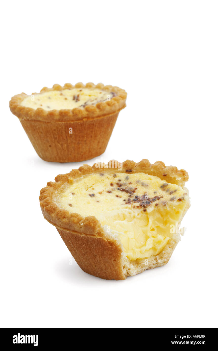 Two custard tarts on white background one with bite taken out Stock ...