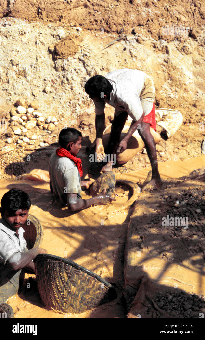 4 Mud is swirled around washing out the stones in gem mining near ...