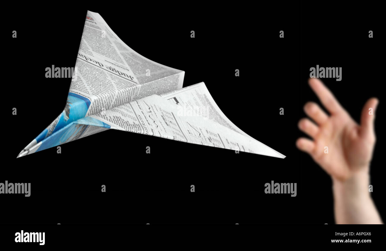 A person throwing a Paper airplane made from newspaper Stock Photo - Alamy