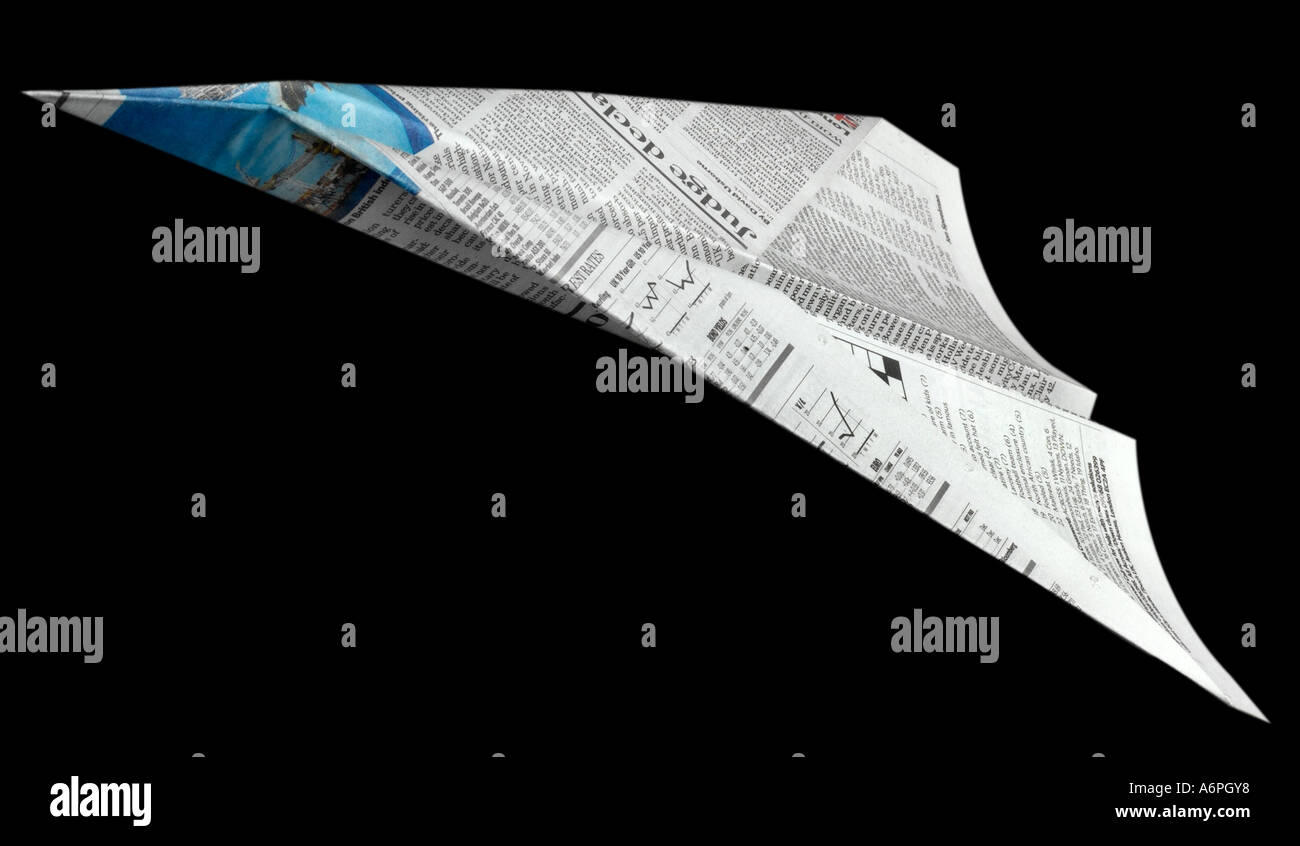 A person throwing a Paper airplane made from newspaper Stock Photo - Alamy