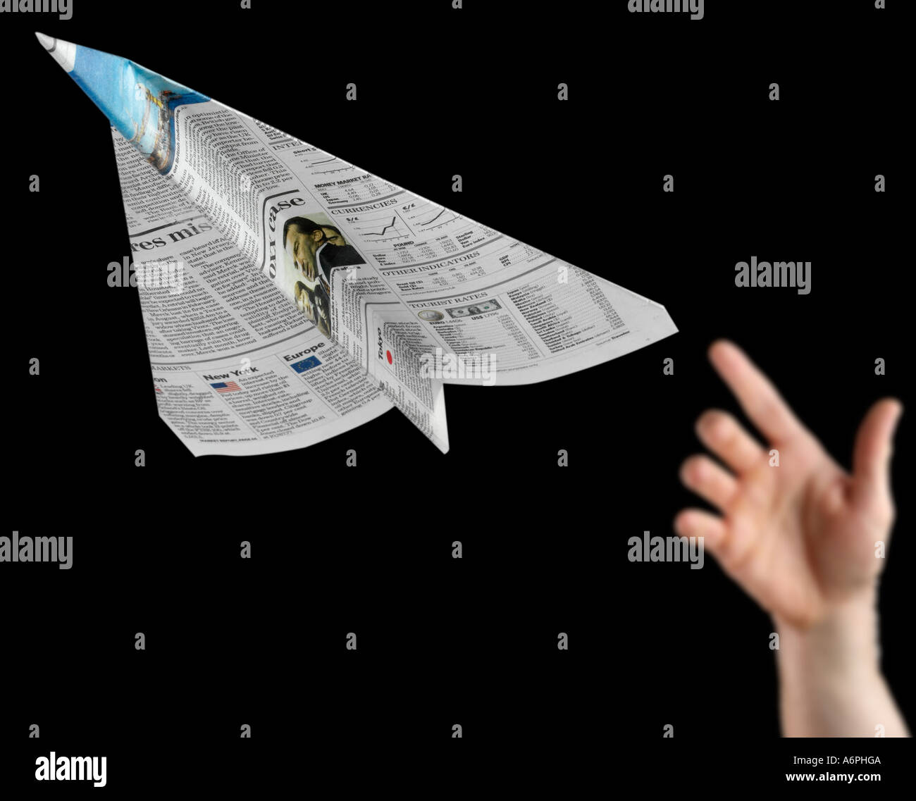 A person throwing a Paper airplane made from newspaper Stock Photo - Alamy