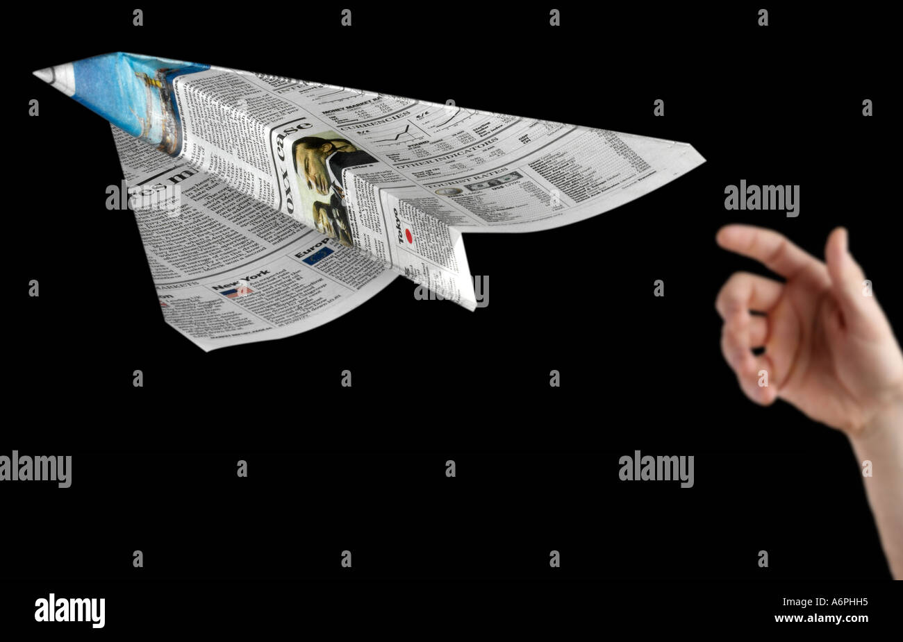 A person throwing a Paper airplane made from newspaper Stock Photo - Alamy