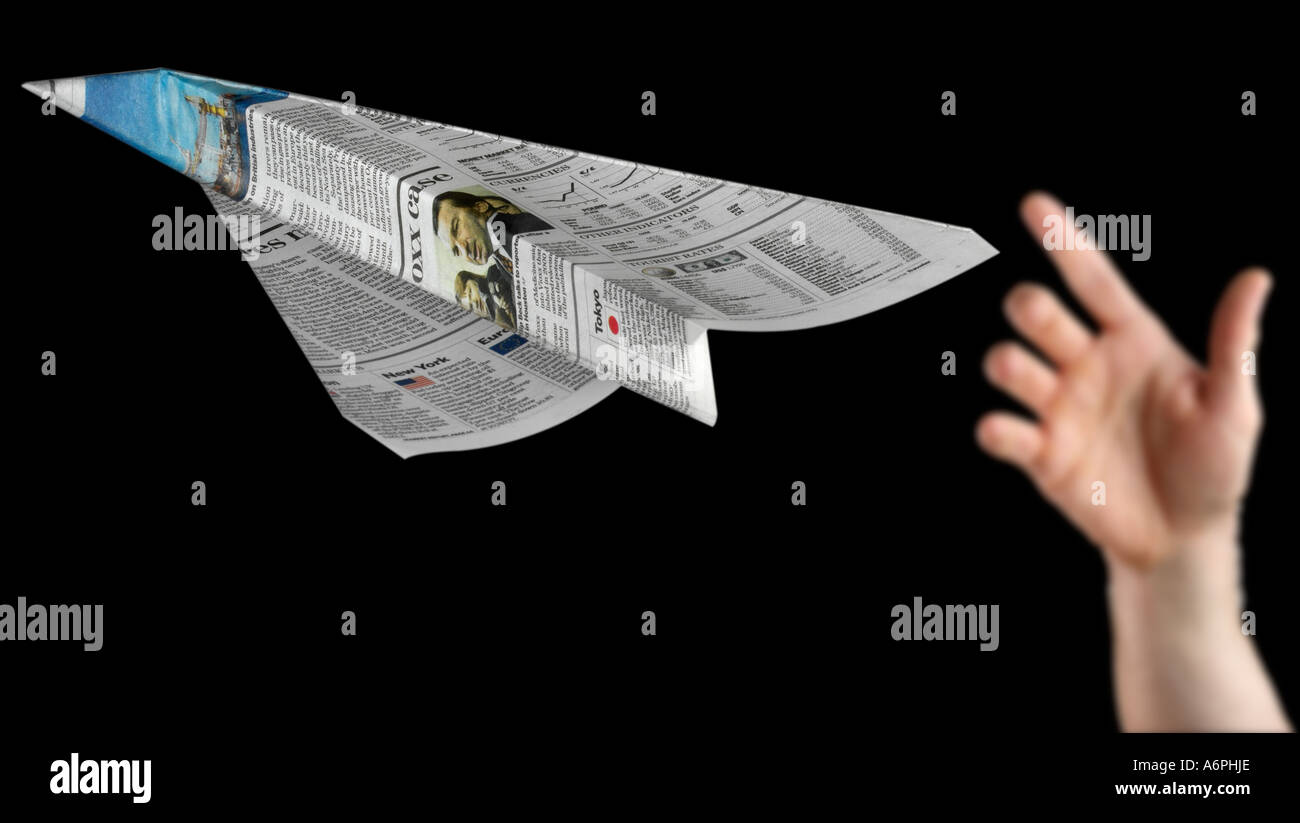A person throwing a Paper airplane made from newspaper Stock Photo - Alamy