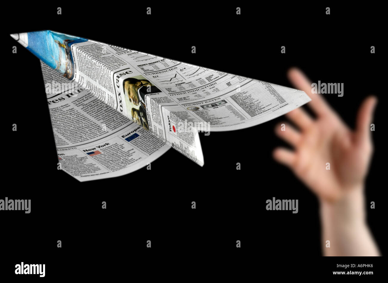 A person throwing a Paper airplane made from newspaper Stock Photo - Alamy