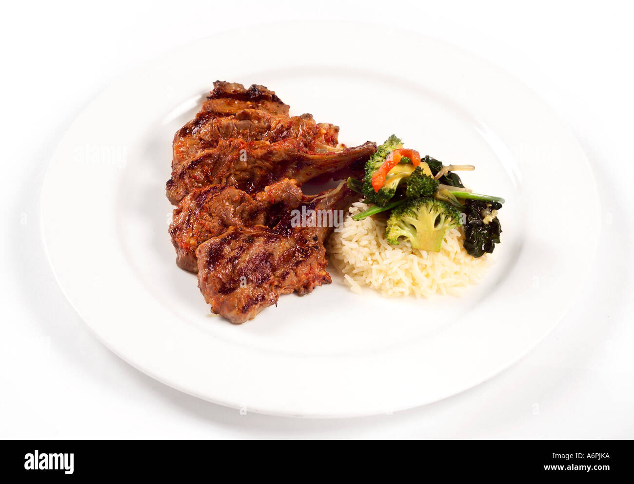 A PLATE OF LAMB CHOPS WITH RICE AND VEGETABLE GARNISH Stock Photo - Alamy