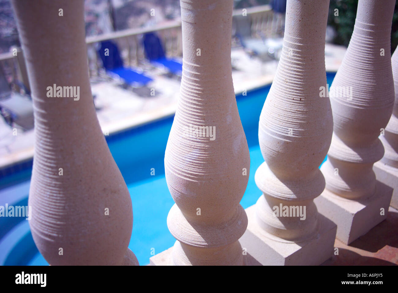 POOLSIDE VIEW THROUGH STONE SCULPTED PILLARS Stock Photo - Alamy