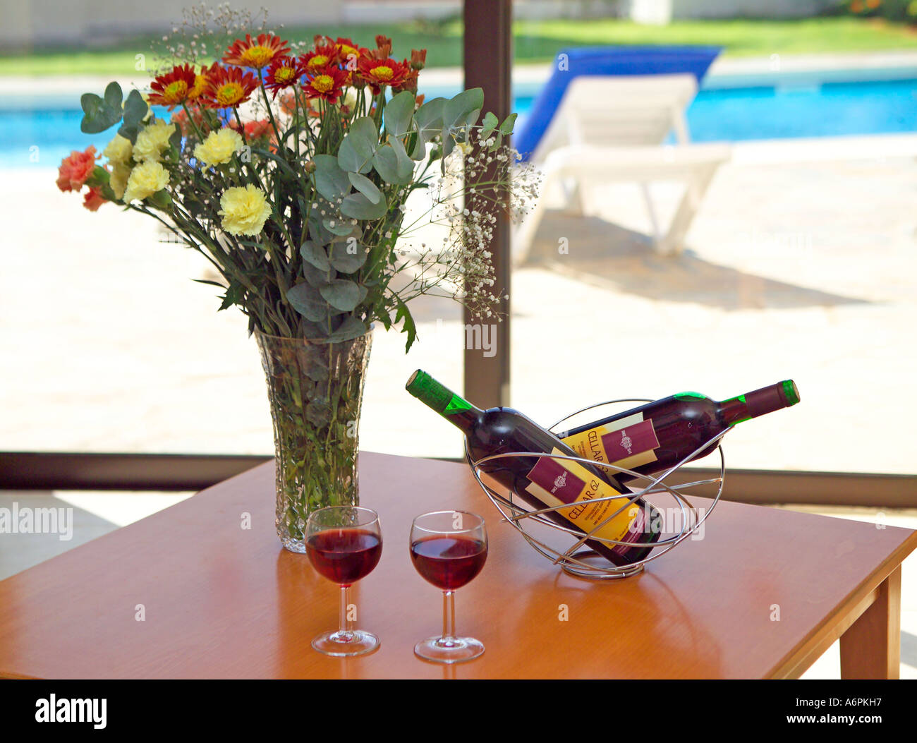 BOTTLE OF LOCALLY PRODUCED CYPRUS RED WINE AND TWO GLASSES WITH ...