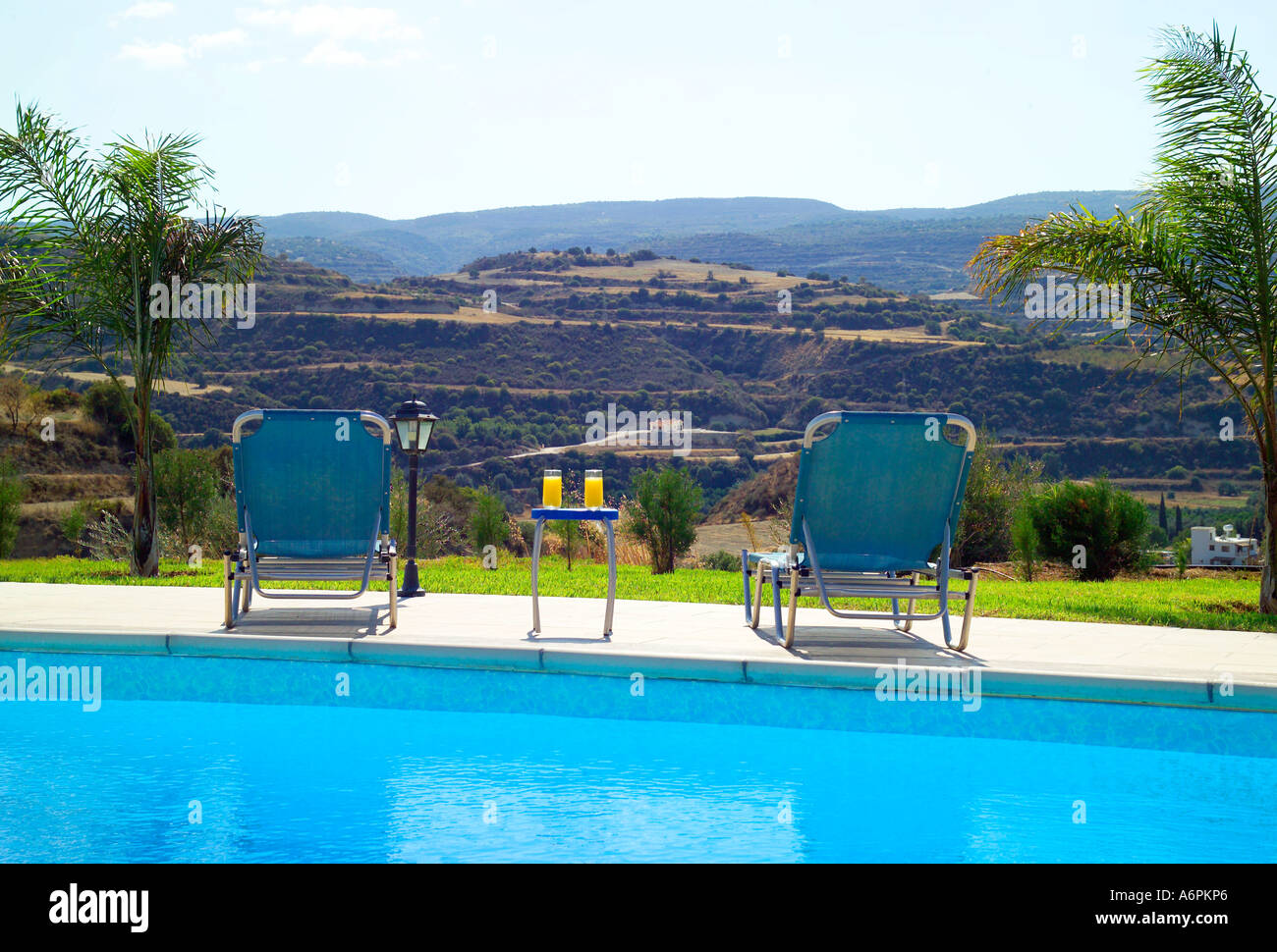 scenic view of sunbeds and swimming pool in cyprus with drinks Stock ...